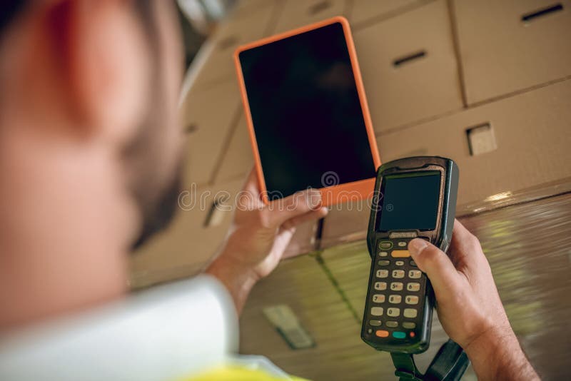 Close Up of Workers Hands Holding Tablet and Scanner Stock Image ...