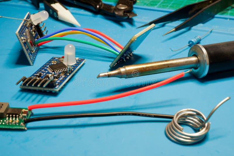 Close-up of a Workspace with Soldering Iron, Schematics and Wires ...