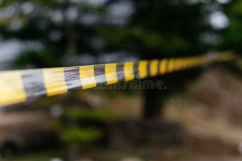 A Close-up of a Yellow and Black Caution Tape Stretched Across an ...