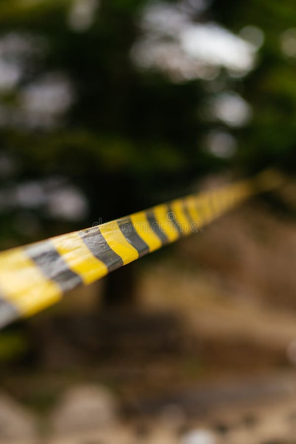 A Close-up of a Yellow and Black Caution Tape Stretched Across an ...