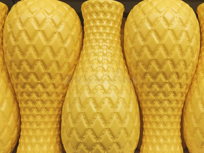 Close-Up of Yellow Decorative Vases with Textured Patterns in a Row ...
