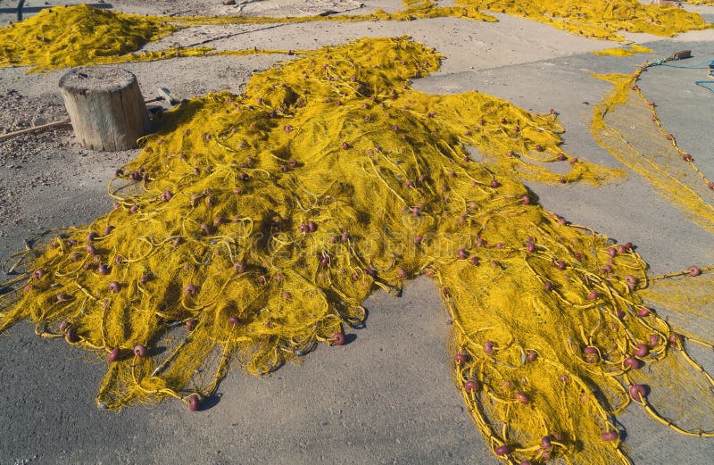 Yellow Fishnet Laying on a Pier Stock Image - Image of laying ...
