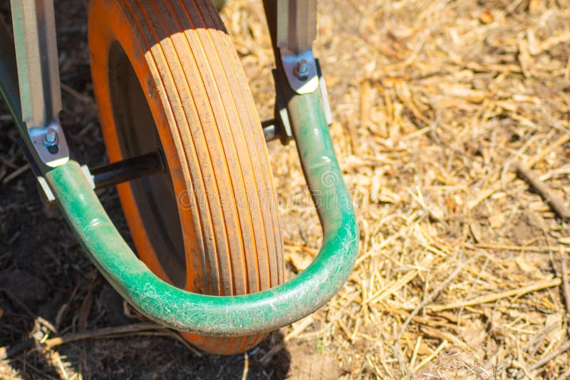 Close-up of a Yellow and Green Wheelbarrow Wheel, Work Tool Concept ...