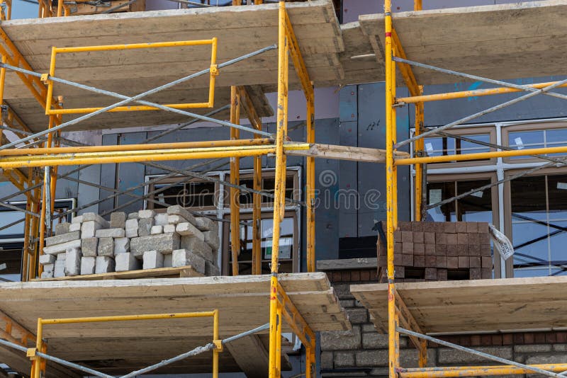 Yellow Scaffolding on Home Building Site Stock Image - Image of tube ...