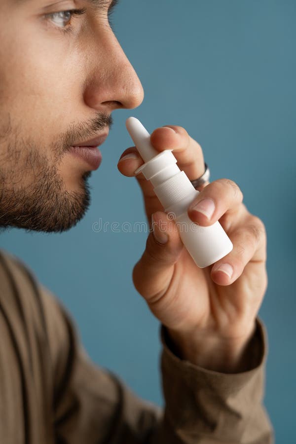 Close-up of Young Arabic Man Spraying Drops in Nose. Stock Image ...