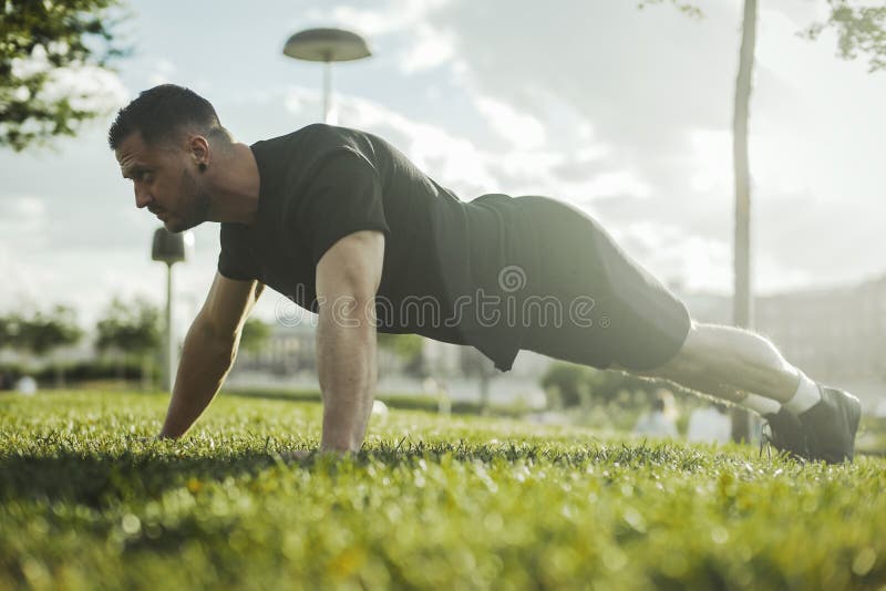 Close Up of Young Attractive Man Exercising Plank Outdoors. Side View ...