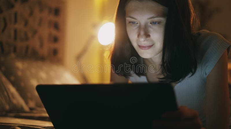 Close-up of Young Attractive Woman Using Tablet Computer at Night Time ...