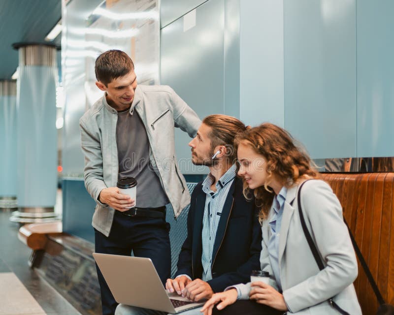 Young Business People Discussing Work Issues on the Subway Platform ...