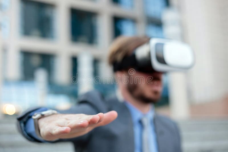 Close Up of a Young Businessman Using VR Goggles in Front of an Office ...