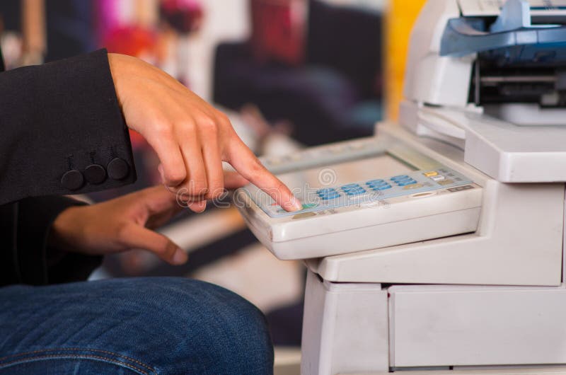 Close Up of a Young Businesswoman Using Copy Machine at the Office ...
