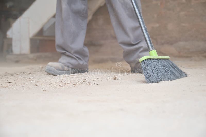 Unrecognizable Young Builder Sweeping the Floor at a Construction Site ...
