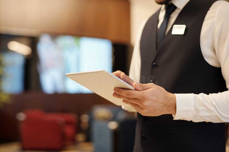 Close-up of Young Male Receptionist Using Tablet during Work Stock ...