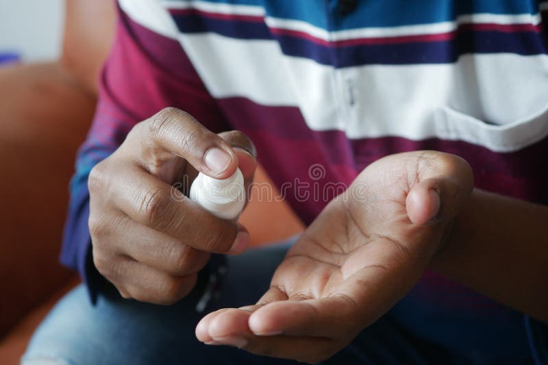 Close Up of Young Man Hand Using Hand Sanitizer Spray. Stock Photo ...