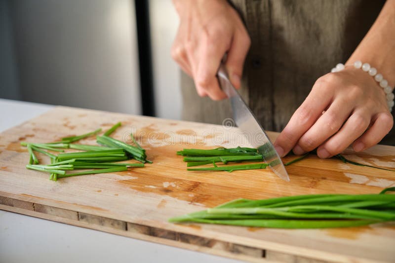 Close Up of Young Man Hands Cutting Chinese Chive at Kitchen. Stock ...