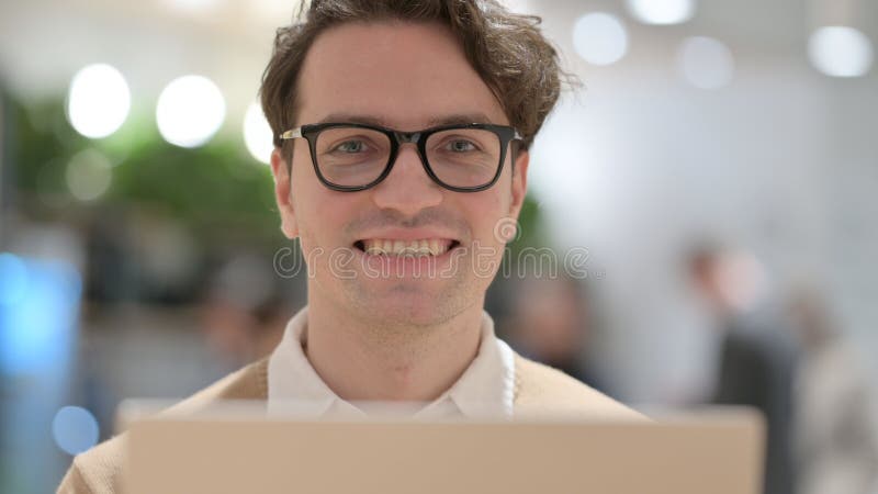 Close Up of Young Man with Laptop Smiling at the Camera Stock Image ...