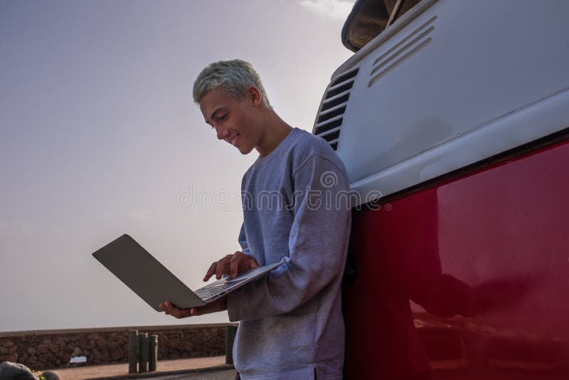 Close Up of Young Man Using His Laptop and Computer Alone at the ...