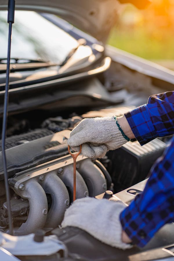 Close-up of a Young Mechanic Checking the Fuel Level for a Trip. Stock ...