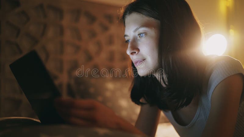 Close-up of Young Pretty Woman Using Tablet Computer at Night Time ...