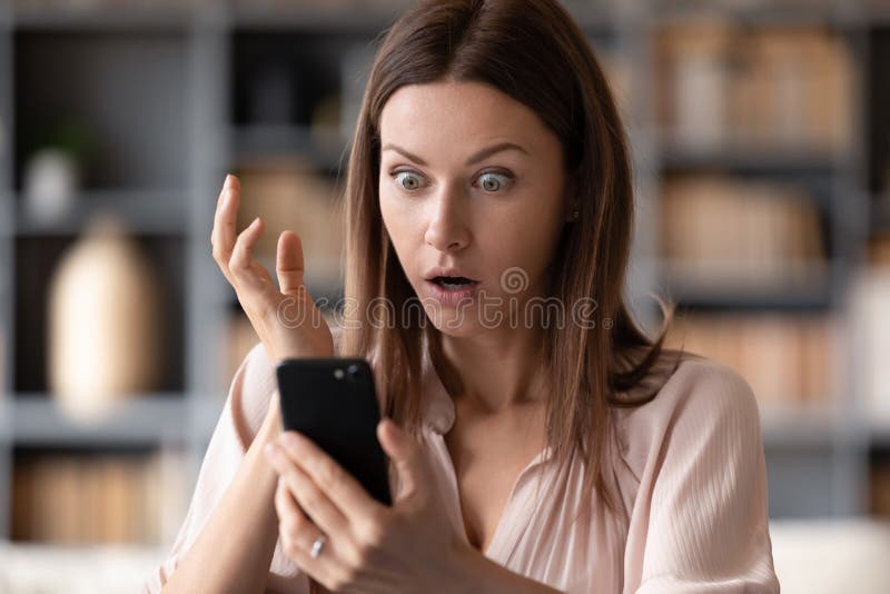 Close Up Young Shocked Woman Looking At Mobile Phone Screen Stock