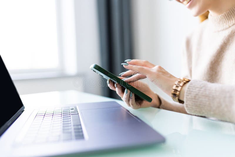 Close Up of Young Woman Hands Using Laptop Checking Smart Phone at Home ...