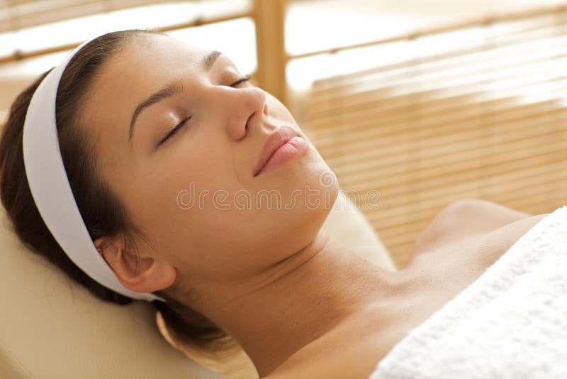 Close Up Of Young Woman Relaxing On Massage Table Eyes Closed Stock