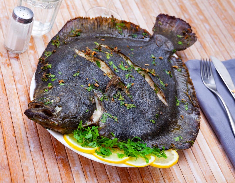 Close View of Baked Flounder on Plate with Parsley Stock Photo - Image ...