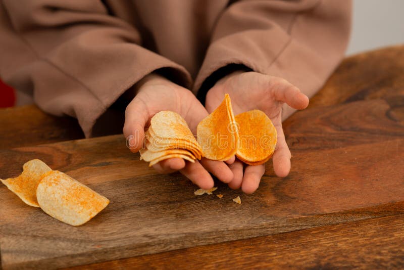 A Close View of a Hand Picking a Chip from a Spread of Chips on a Table ...