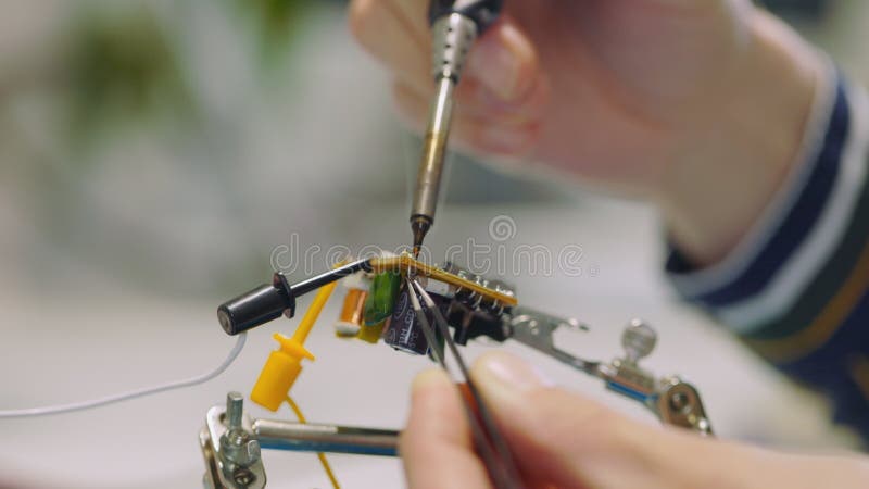Close View of the Man Engineer Hands Soldering Iron Mother Board. Stock ...