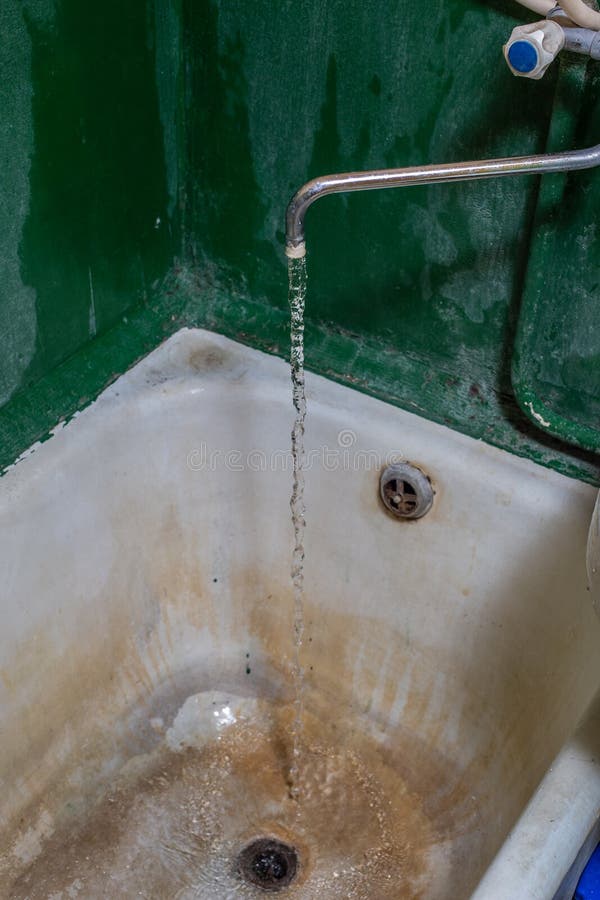 Close View of Old Stained Water Tap and Rusted Bathtub with Selective ...