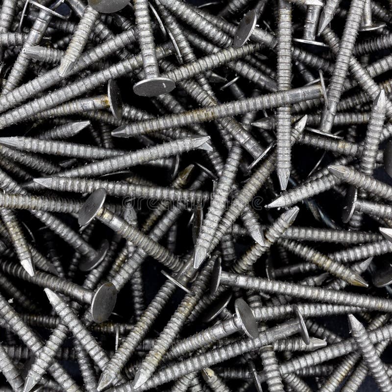 Group of Ring Shank Underlayment Nails on a Dark Paper Background Stock ...