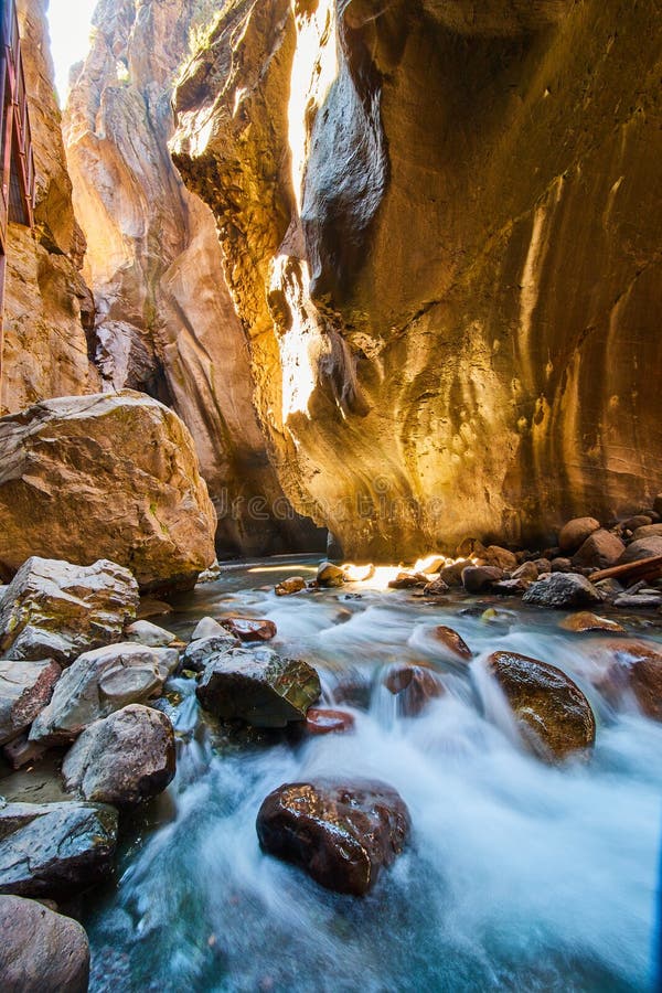Close View of Waterfalls Over Red Rocks at Bottom of Deep Canyon with ...