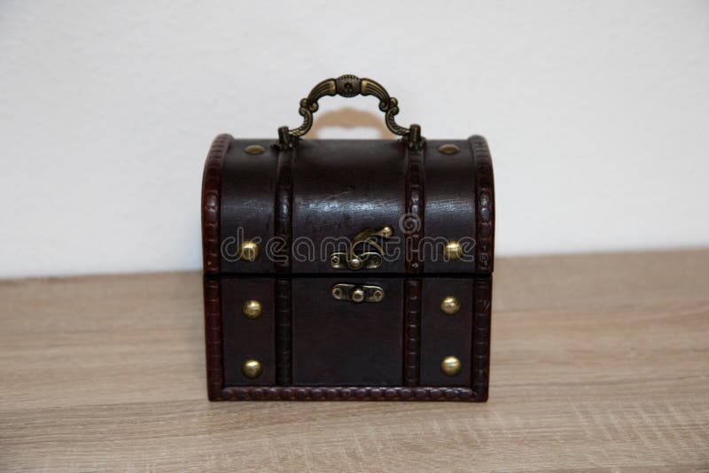 Closed Brown Treasure Chest on a Wooden Surface Stock Image - Image of ...