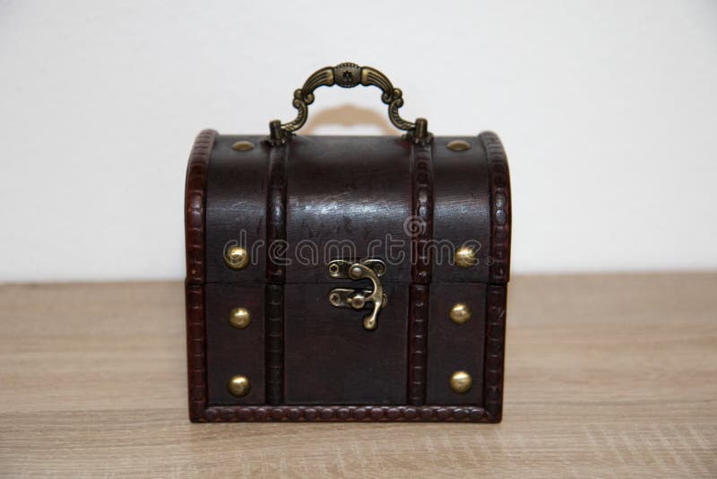 Closed Brown Treasure Chest on a Wooden Surface Stock Image - Image of ...