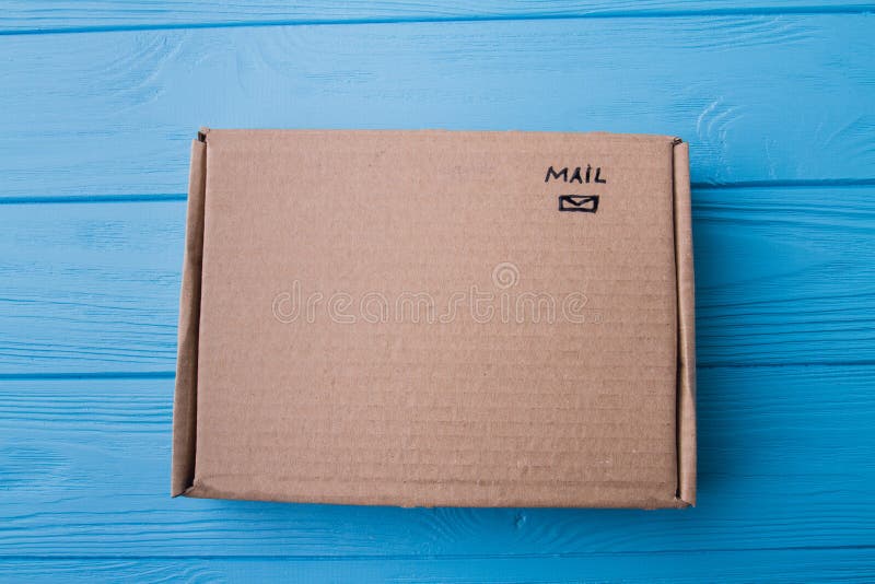 Closed Cardboard Box on Blue Wood. Stock Image - Image of card ...