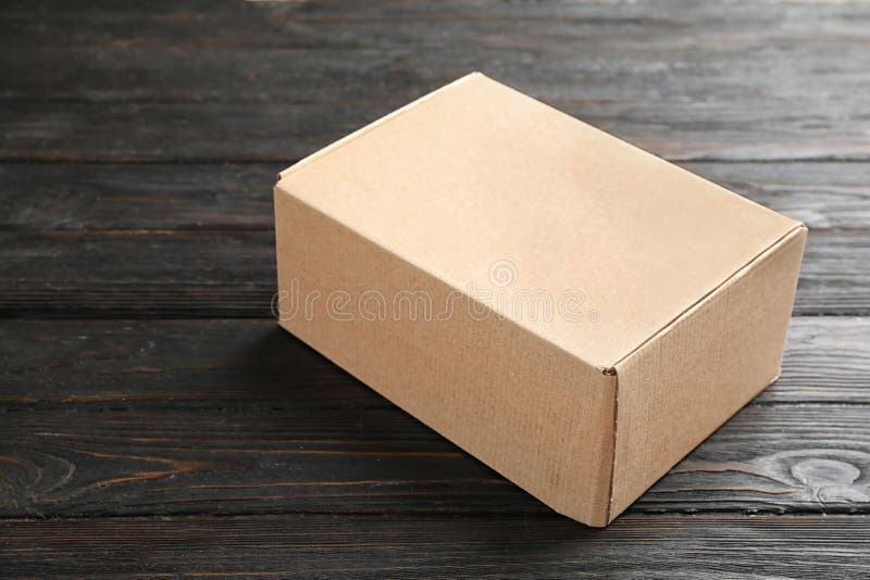 Closed Cardboard Box on Dark Table Stock Image - Image of cardboard ...