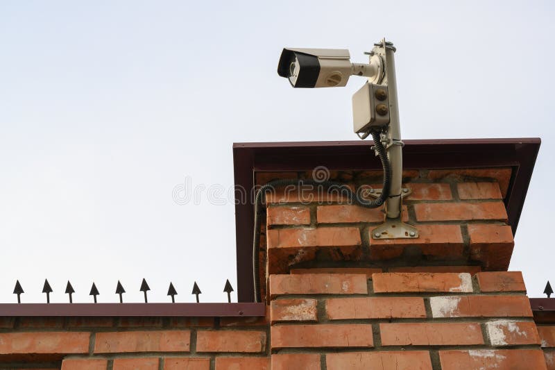 Closed-circuit Television Camera on a Brick Wall with Iron Spikes Stock ...