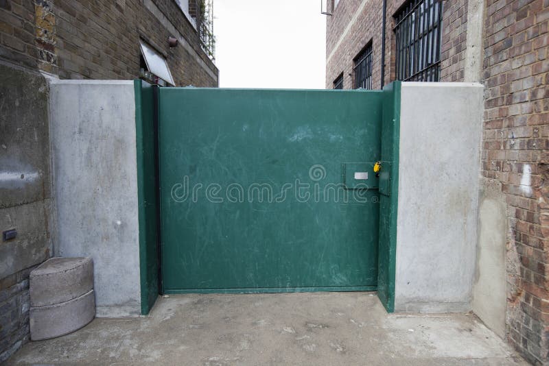 Closed Green Gate Connected To Buildings Stock Image - Image of ...