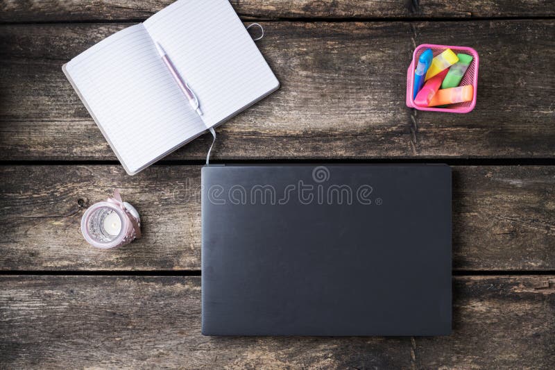 Closed Laptop Computer, Notepad and Colorful Markers on Rustic Wooden ...