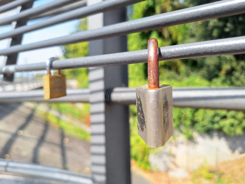 A Closed Lock Hangs on an Iron Pipe of the Bridge Stock Image - Image ...