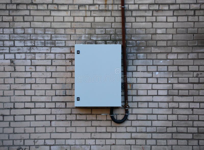 Closed Metal Electrical Panel on a White Brick Wall Stock Photo - Image ...