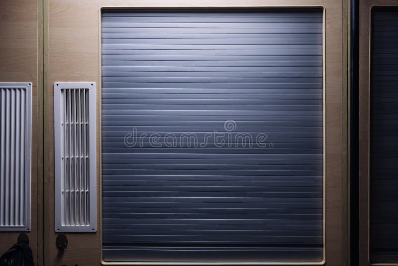 Closed Rolling Shutter Door and Ventilation Grilles in a Modern ...