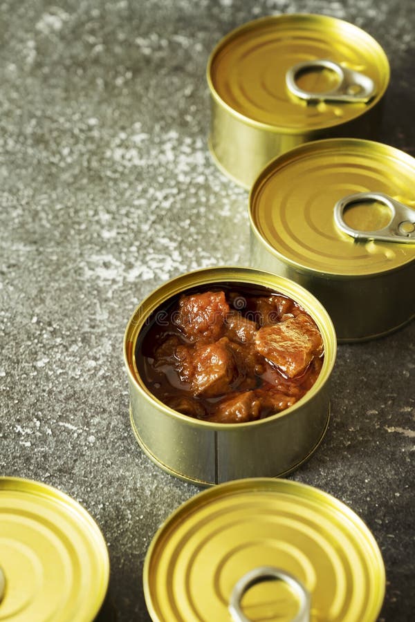 Closed Round Small Cans Except One with Pieces of Squid in Sauce on a ...