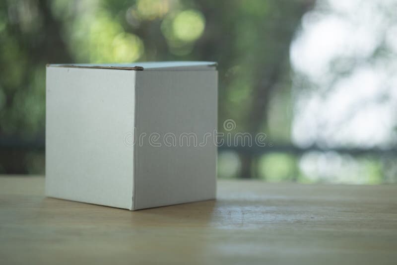 Closed White Blank Cube Box on Wood Table Stock Photo - Image of ...