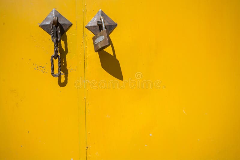 Closed Yellow Doors with Lock Stock Photo - Image of shadow, horizontal ...