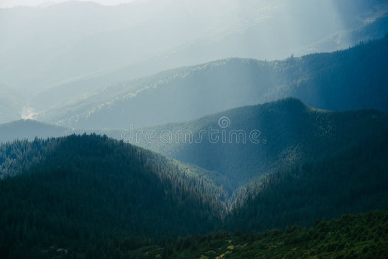 Rays of Sun Beaming through Clouds in the Carpathian Mountains Stock ...