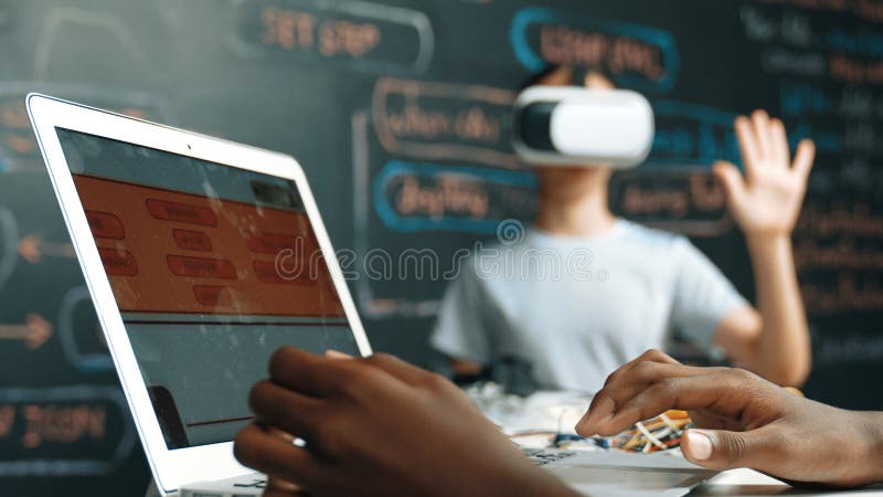 Closeup of African Student Hands Programing System at Blackboard ...