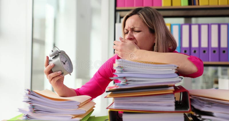 Closeup of Alarm Clock and Tired Female Worker Dozing on Huge Pile of ...