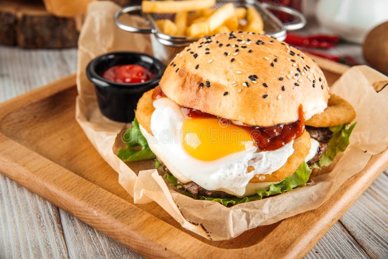 Appetizing Burger on a Wooden Tray with Knife, with French Fries Stock ...