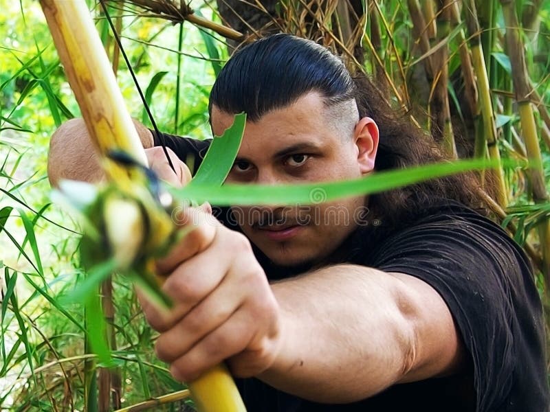 Closeup of an Archer Aiming at the Camera with a Menacing Expression ...