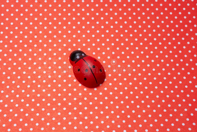 Closeup of an Artificial Small Ladybug on a Red Polka Dot Surface Stock ...